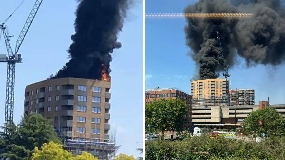 Huge plume of smoke billows into the sky as massive fire engulfs ...