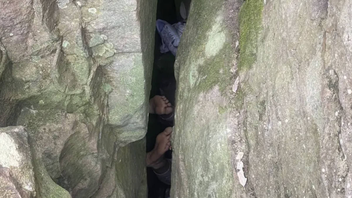 Woman stuck upside down between two boulders while trying to retrieve ...