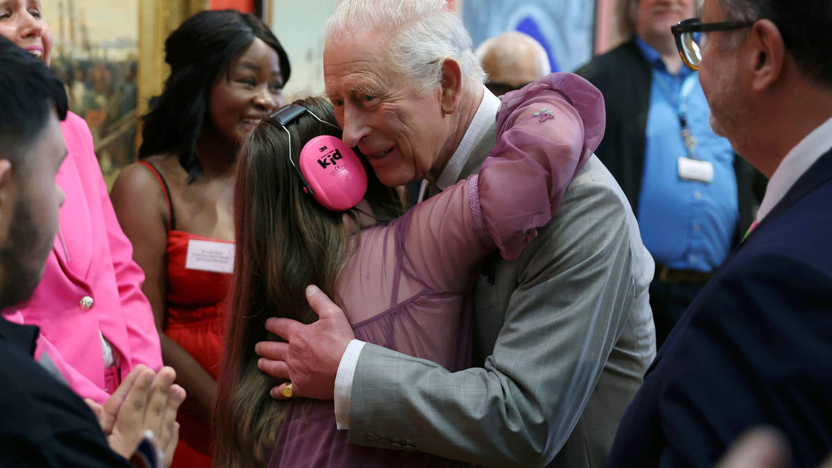 Teenager embraces King Charles with ‘awesome’ hug | LBC