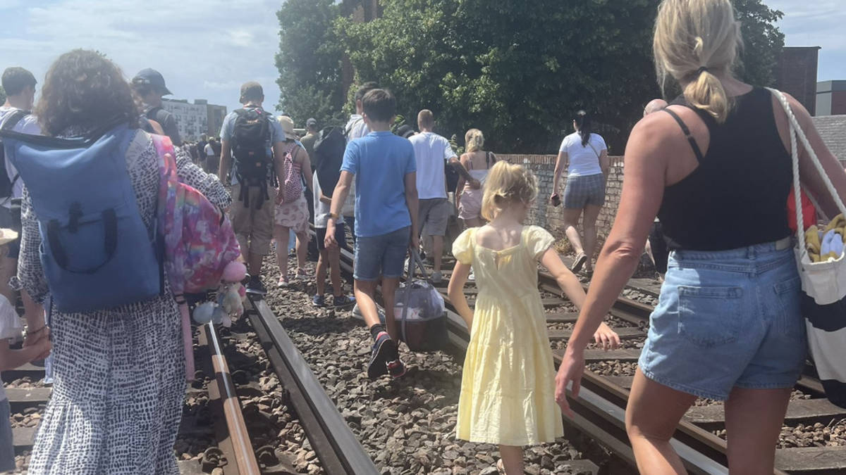 Mass evacuation of passengers 'trapped' on broken-down train on hottest ...