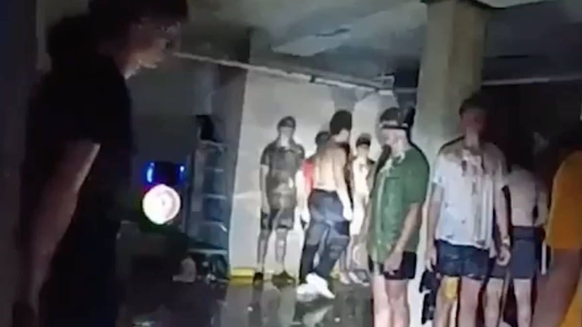 Chilling moment police find 56 shirtless, blindfolded young men with ...
